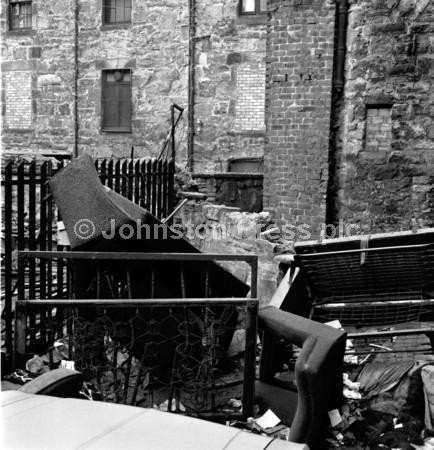 20235681-The discarded furniture and other rubbish dumped behind the ...