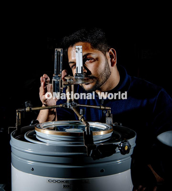 39978237-Compass adjuster Sylvester Perera taking a bearing using ...