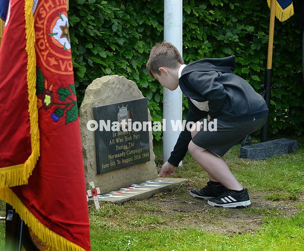 39983293-A pupil from High Greave School lays a cross at the Normandy ...