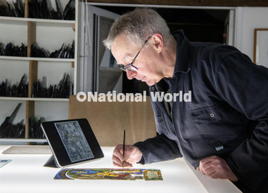 40367158-Stained glass conservator Jonathan Cooke restoring a small ...