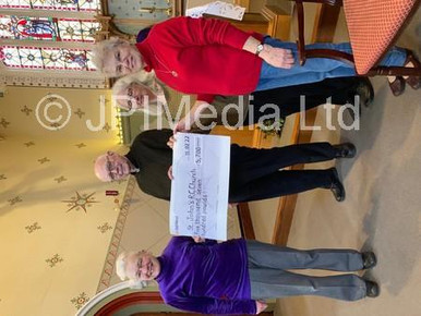 39350938-Frances Levett left presents a fundraising cheque to Father ...