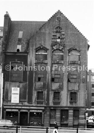 20384664-A derelict buildin with the Draw Bridge Tavern on the gound ...