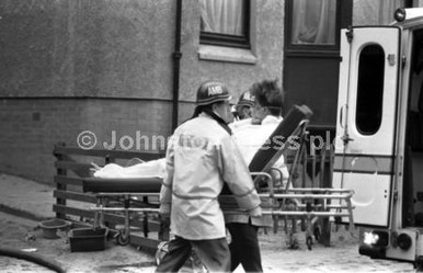 22701420-Ambulancemen move an injured survivor of the Guthrie Street ...