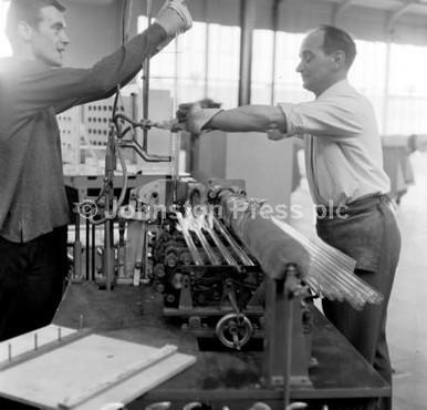23443348-Men using machinery for bending glass tubes at the Philips ...