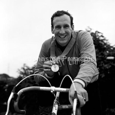 20235104-Scottish cyclist Brian Temple shows the silver medal he won in the Commonwealth Games ...