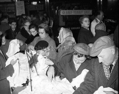 19998150-Customers enjoying a rummage at the Half-yearly sale at ...