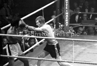20327323-Jim Watt pushes Robert Vasquez back onto the ropes in the ...