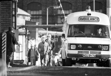 22619495-Some miners walk away while others are taken out by ambulance ...