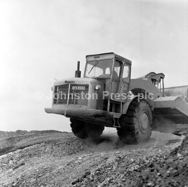 20364964-A 20-ton scaper removes the top layer of the burning bing at ...