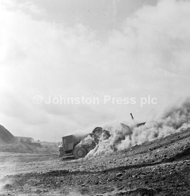 20364967-A 20-ton scaper removes the top layer of the burning bing at ...