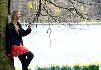 38937979-Cat Thomson from Leeds in Roundhay Park checking Tik Tok on ...