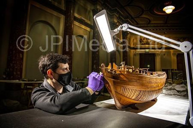 38978829-14 May 2021. . . . . Conservator Stathis Tsolis works on model ...