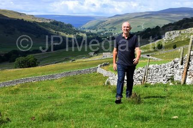 39079571-Richard Stockdale on his farm high above Conistone with a ...