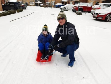 38897444-More snow fall on South Tyneside. Stuart Rosamond with son ...