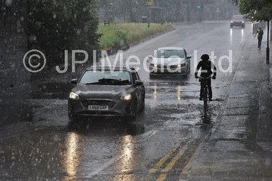 38707817-Rain, weather, flooding pix . traffic gong under Oundle Road ...