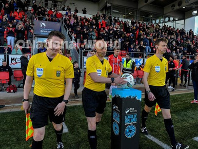 39695693-Match referee Neil Doyle leads the teams onto the pitch at the ...