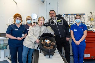 39367457-Proud parents with the staff who helped with the delivery ...