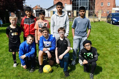 39708945-Boys enjoying a game of football during the celebration of the ...