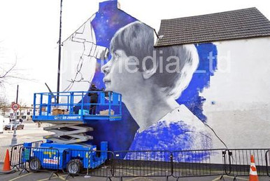 39378985-Zabou - a French artist is seen painting a mural on a building ...