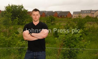 34825075-Andrew Jarmin photographed on the land across from his house ...