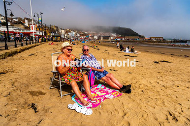 39855496-Esther and Ed Harding from Burniston relaxing on the South Bay ...
