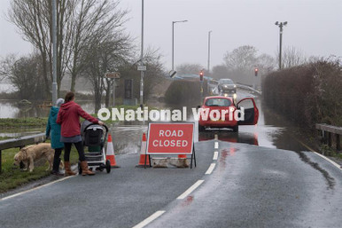 39905866-A driver checks the water level during flooding at Bubwith ...