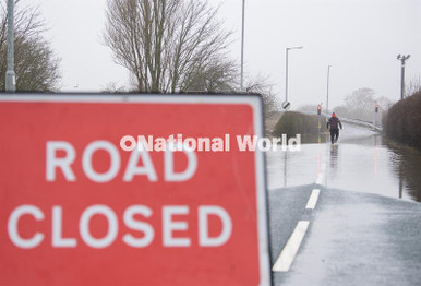 39905864-A driver checks the water level during flooding at Bubwith ...