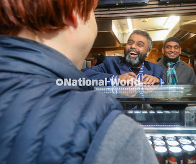 39932142-Owner Shamsul Alam (centre, in blue jacket) with customers and ...