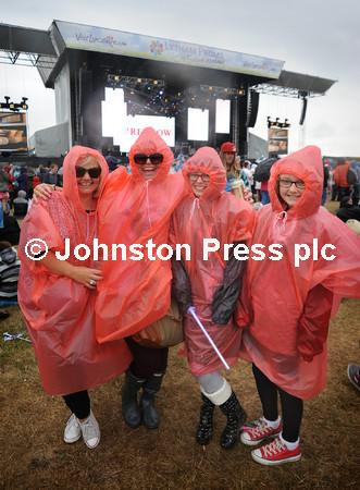 25252404-Sunday night at Lytham Proms. Braving the weather are L-R ...