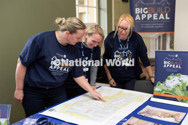 39960001-Team from Overgate Hospice showing plans and fundraising for ...