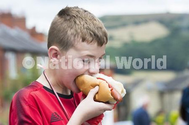 39499482-Elland Carnival. Daniel Cragg, 10, tucks in to a hotdog ...