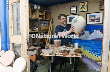 39985845-Artist Joseph Travis in his studio, a converted shipping ...