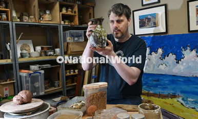 39985846-Artist Joseph Travis in his studio, a converted shipping ...