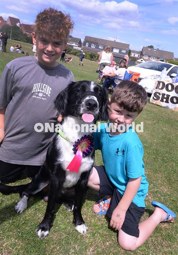 40016464-Harry (left) and Louis Carter with their dog Buddy who took ...
