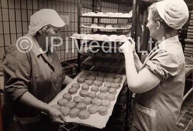 39327867-Burtons Biscuits - Danish pastries being prepared for icing ...