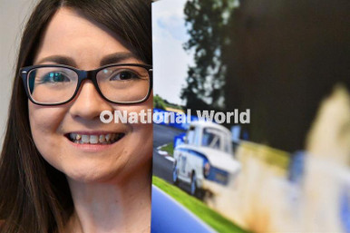 40102753-Photographer Nikki Sim holds one of her action photographs ...