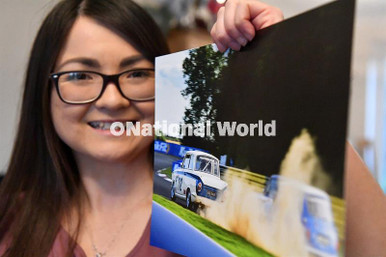 40102752-Photographer Nikki Sim holds one of her action photographs ...