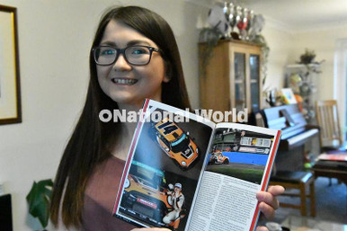 40102756-Photographer Nikki Sim holds one of her action photographs ...