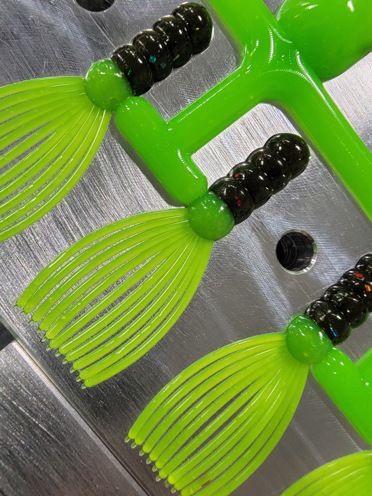 Aluminum Bait mold for making classic grub molds, most have curly tails.