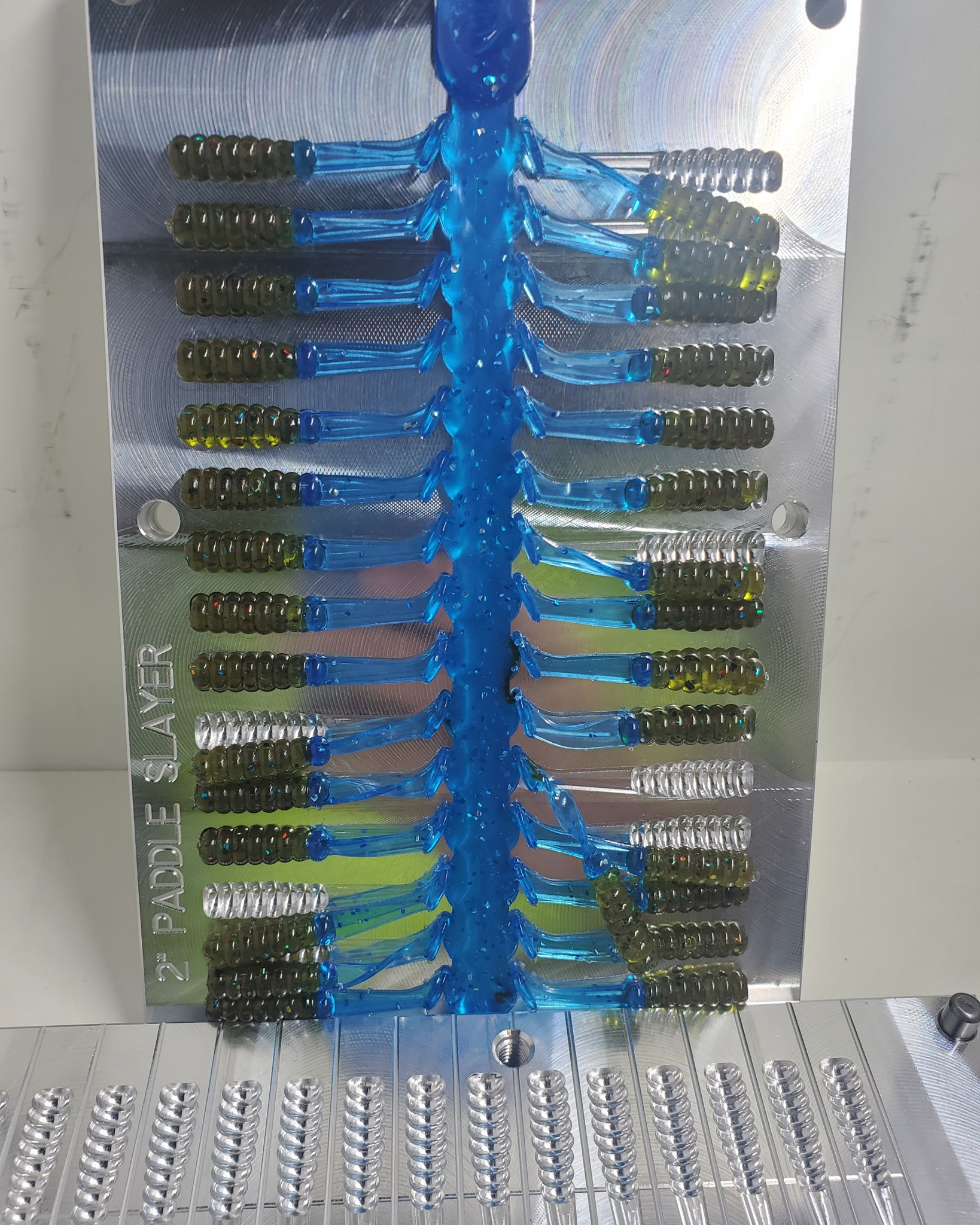 Aluminum Bait mold for making classic grub molds, most have curly tails.