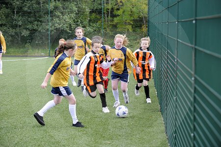 16143678-Primary School girls from Castlemilk play in a football ...