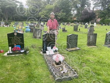 39084179-John Bettles, tends to the grave of his daughter, Michelle ...