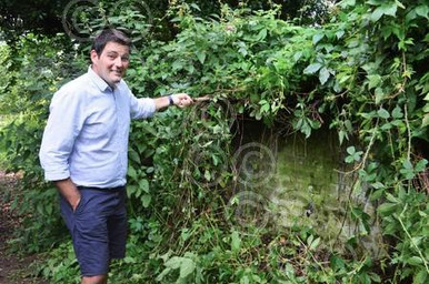 39082673-Luke Paterson pulls back the undergrowth to reveal part of the ...