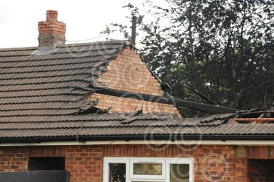39069243-The completely destroyed roof of a bungalow destroyed by fire ...