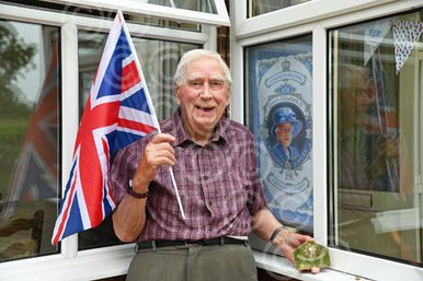 39449290-Harry Prior, holding a flag and the plate which hung above his ...