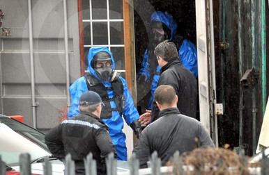 39688356-Investigators in ble protective suits and respirator masks ...