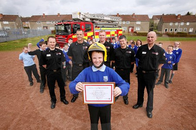 14843289-11 year old Cadder primary pupil Dylan Auld receives a ...