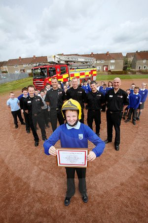 14843290-11 year old Cadder primary pupil Dylan Auld receives a ...