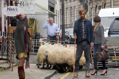27787998-Models pose outside an Edinburgh pub wednesday as sheep pass ...