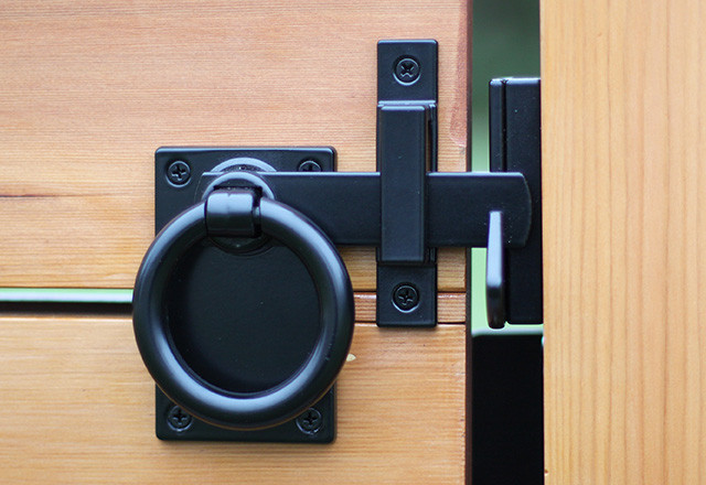 A latch on a gate that is sitting in the middle of the post instead of ...